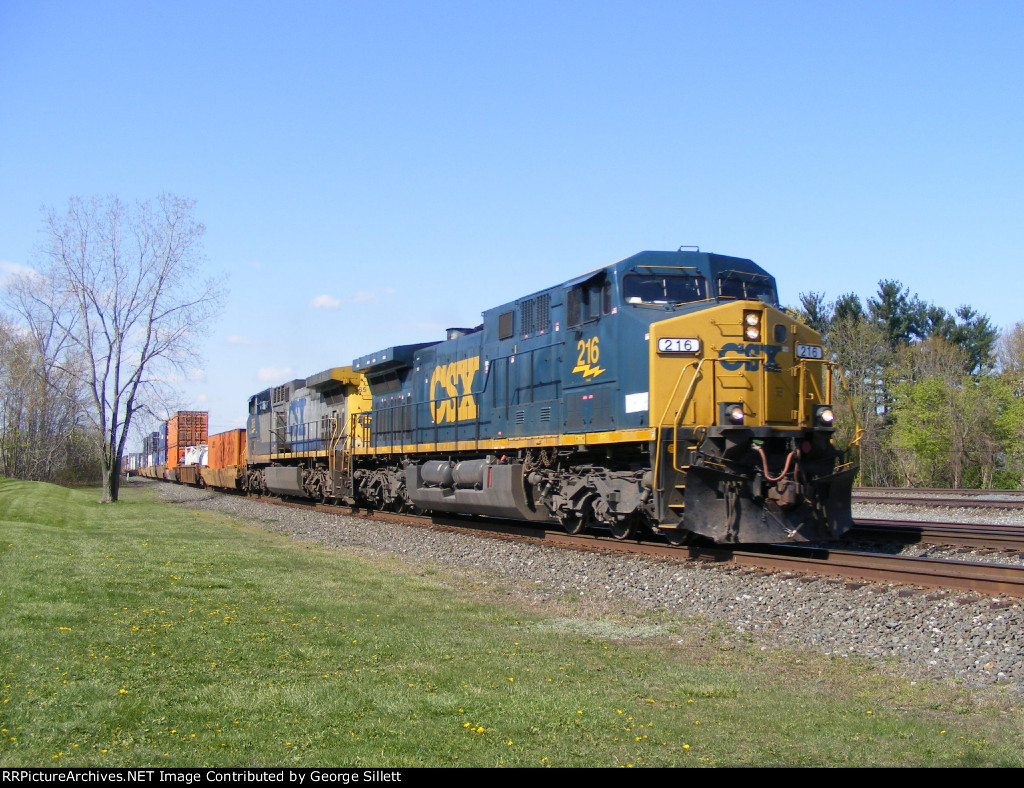 CSX 216 charges east with a large intermodel train in tow.